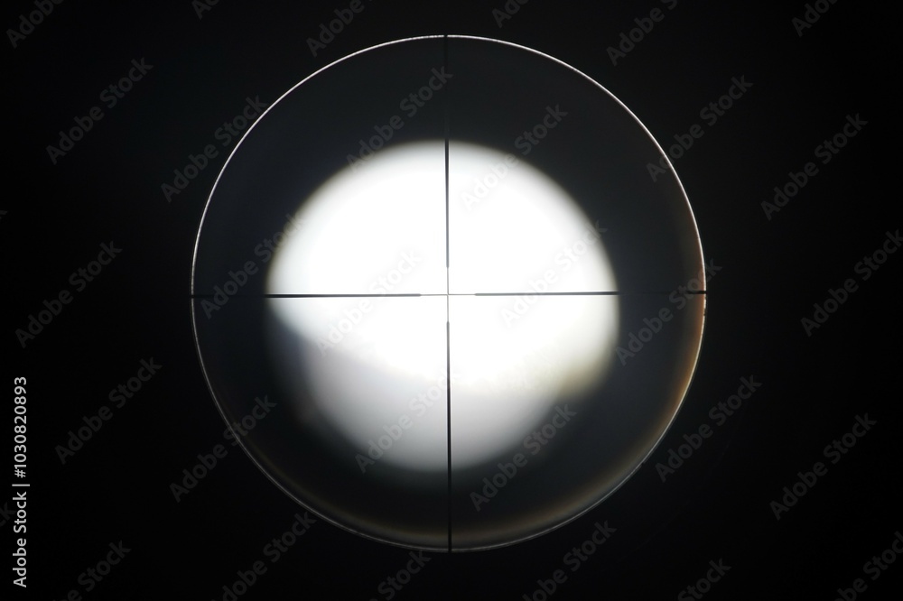 Optical lens with no target markings. Black and white photograph of an ...