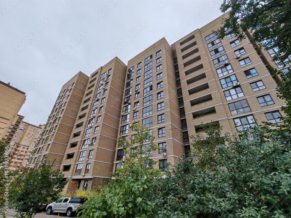 large high-rise building with pastel pink, blue, and white accents on ...