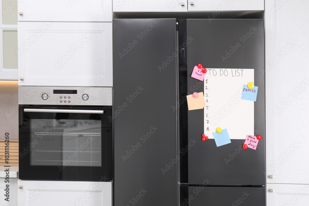 Magnetic board with to do list and notes on refrigerator in kitchen ...