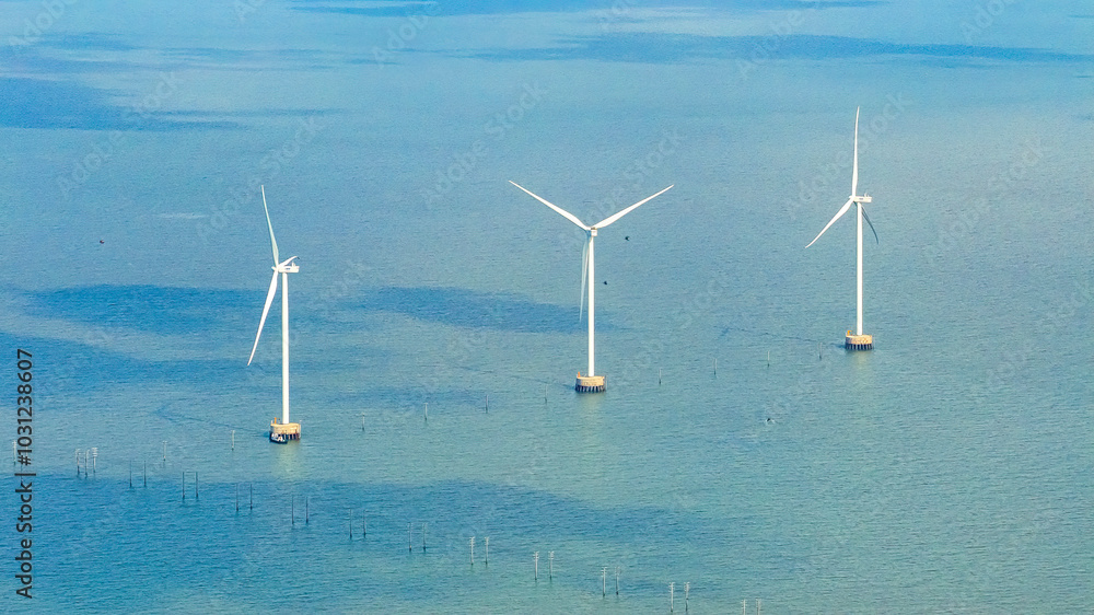 Offshore Windmill farm in the ocean near estuary at Ben Tre, Vietnam ...