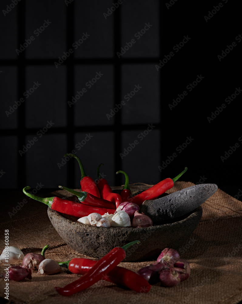 Large red and green chilies are ready to be ground in a stone mortar ...