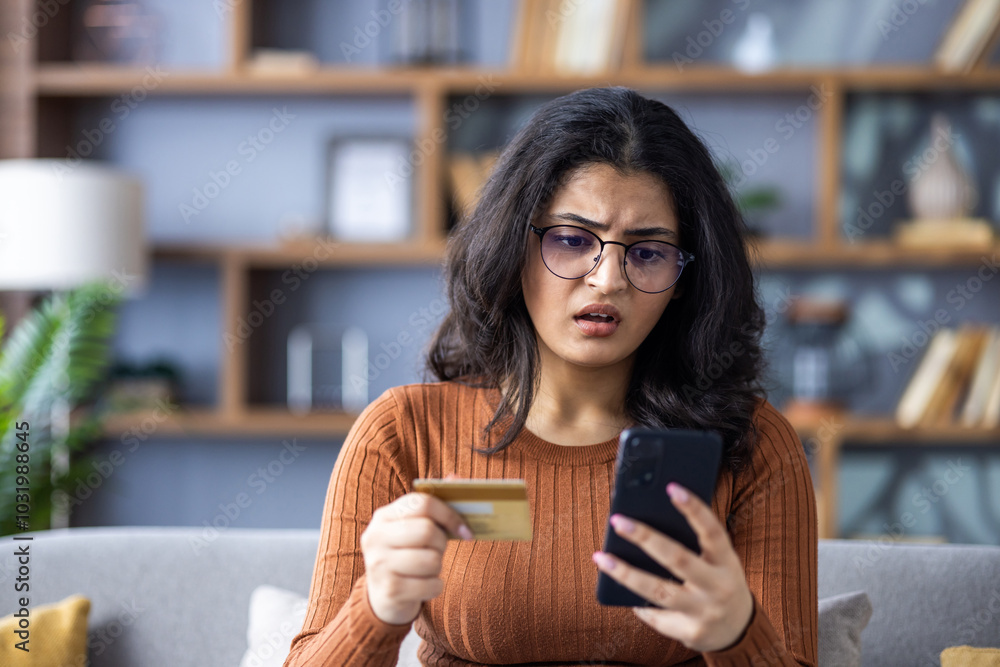 Credit card and billing issues. Photo of a cheerful young confused ...