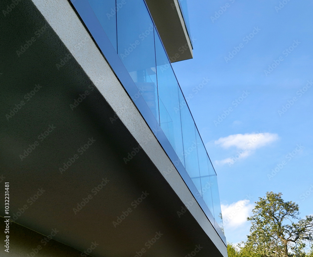 railing of a luxury house formed by glass panels fastened with metal ...