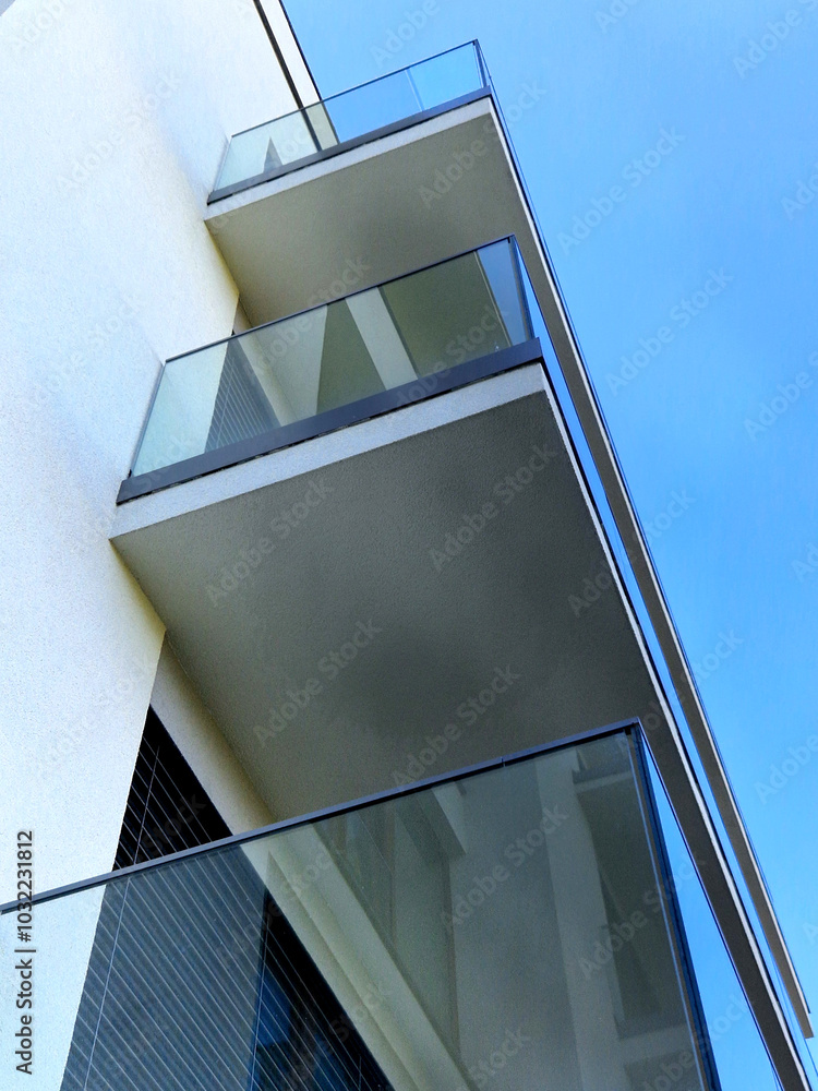 railing of a luxury house formed by glass panels fastened with metal ...