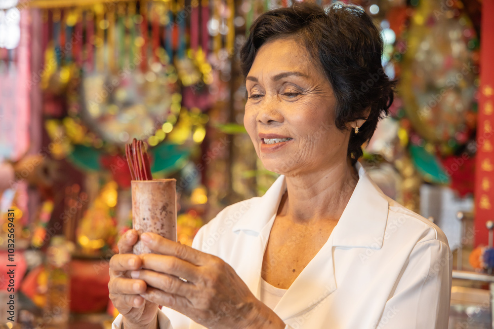 Spiritual senior old woman holding yin yang fortune telling wood ...
