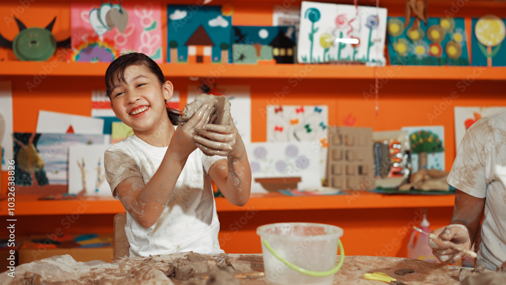 Foto de Asian highschool student modeling clay on table with mud and ...