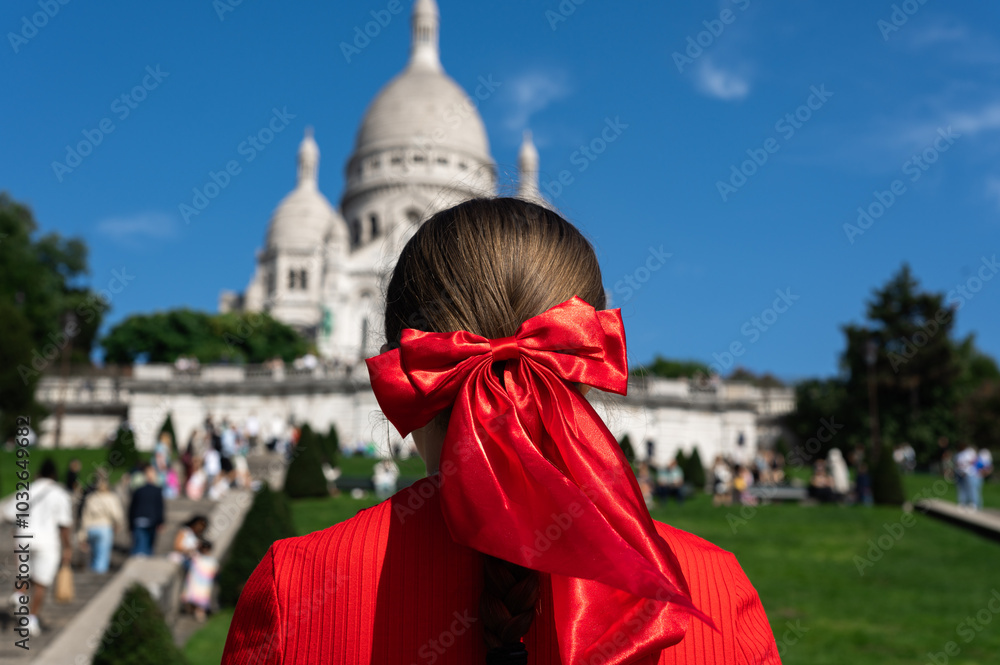 Tourist Girl with red bow in her hair is watching Basilica of Sacre ...