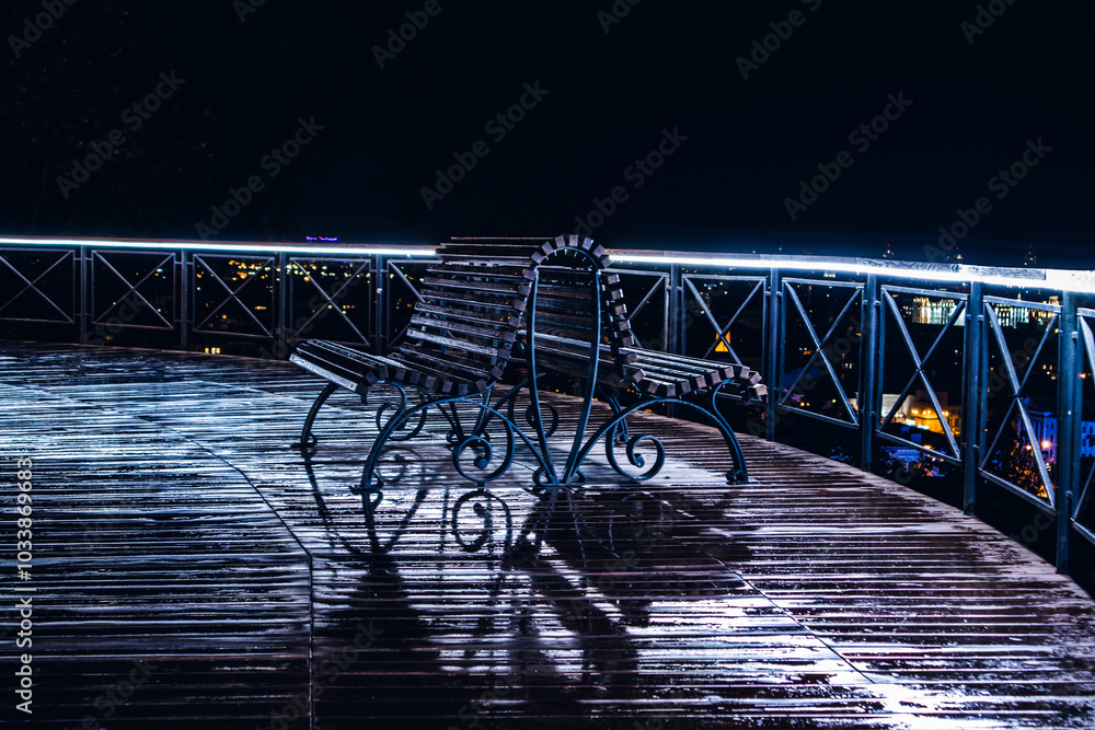 Poster Two wooden benches close-up back to back on a wet observation ...