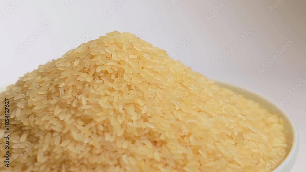 Dry Uncooked Parboiled Rice Heap Rotating against White Background. A ...