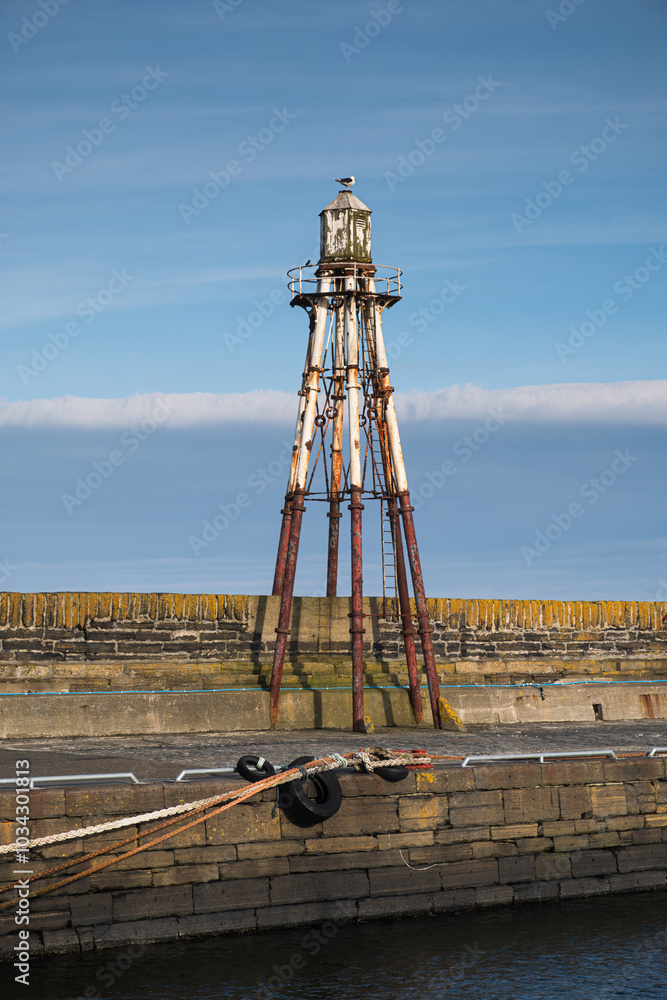 An old iron navigation beacon built on the harbour wall in Wick ...