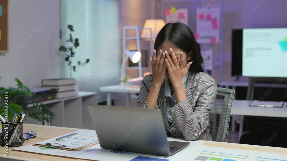 Asian businesswoman stressed and tired from work sitting at desk in ...