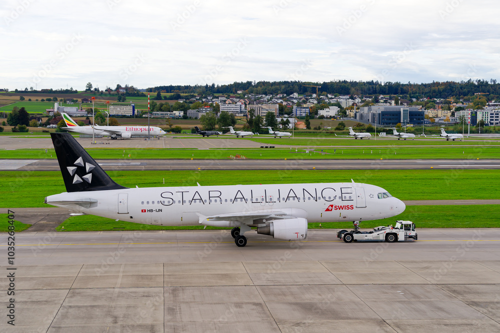 Aircraft Tug pulling Swiss airplane Airbus A320-214 registration HB-IJN ...