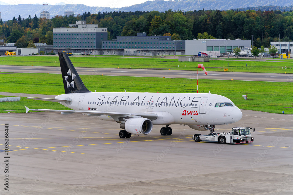 Aircraft Tug pulling Swiss airplane Airbus A320-214 registration HB-IJN ...