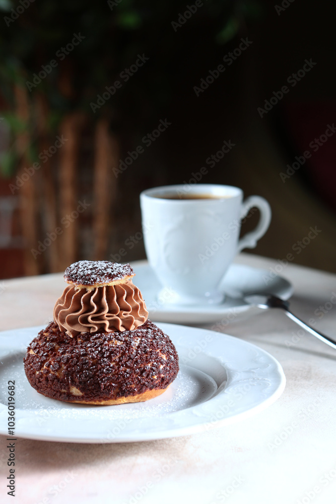 French Shu pastry with peach jam. Custard cake. A cup of coffee. A ...