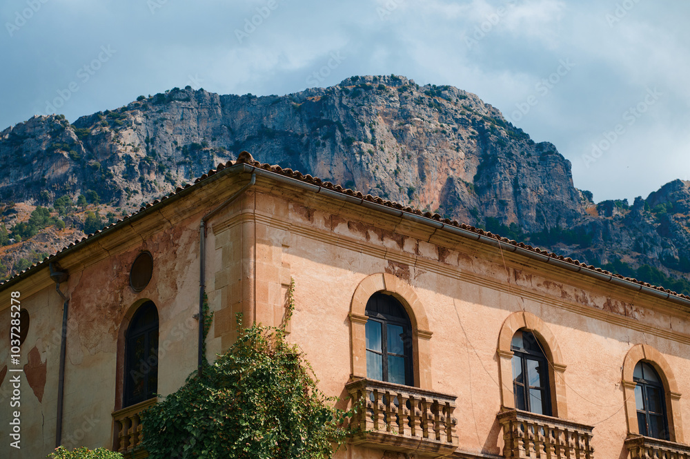 Historic stone building with a scenic mountain backdrop Stock Photo ...