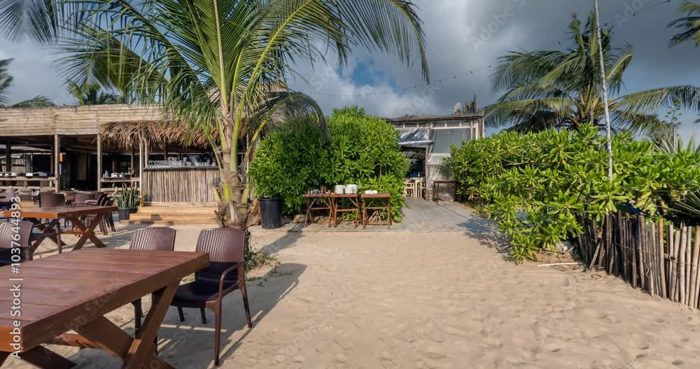 coconut trees on ocean coast near tropical shack or open cafe on beach ...