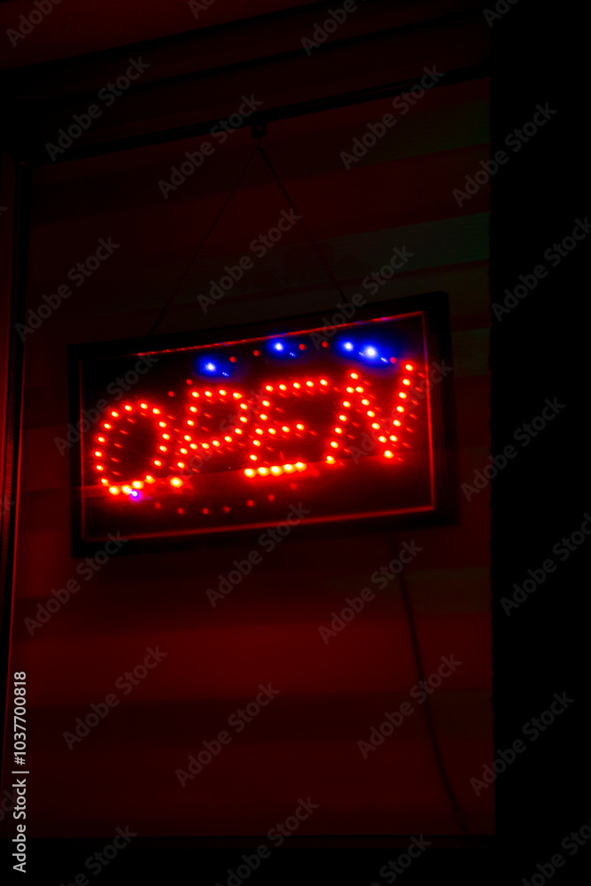 Bright Neon 'Open' Sign Illuminating in Red and Blue Lights Against the ...