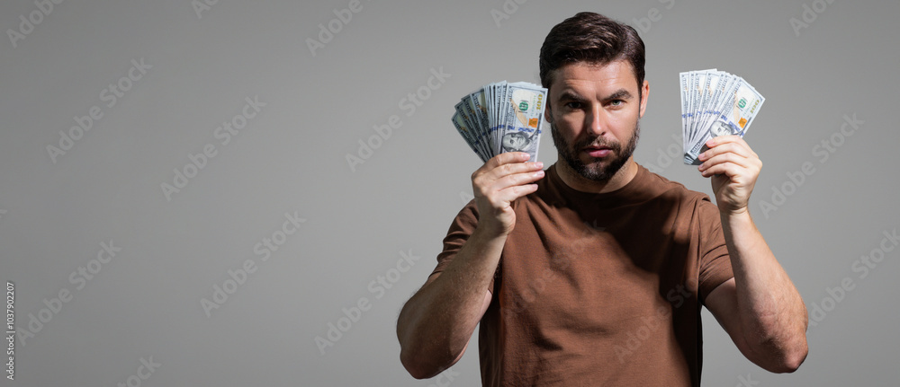 Portrait business man holding cash dollar bills over gray background ...