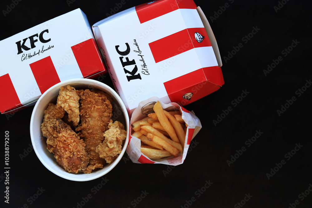 Kyiv, Ukraine - October 20, 2024: KFC. Bucket with strips, burger in paper box and french fries ...