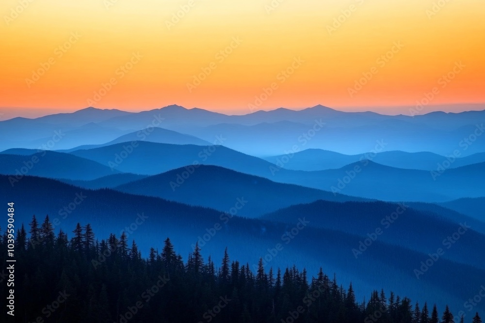 Endless blue mountain ridges stretch across the horizon as the sun sets ...