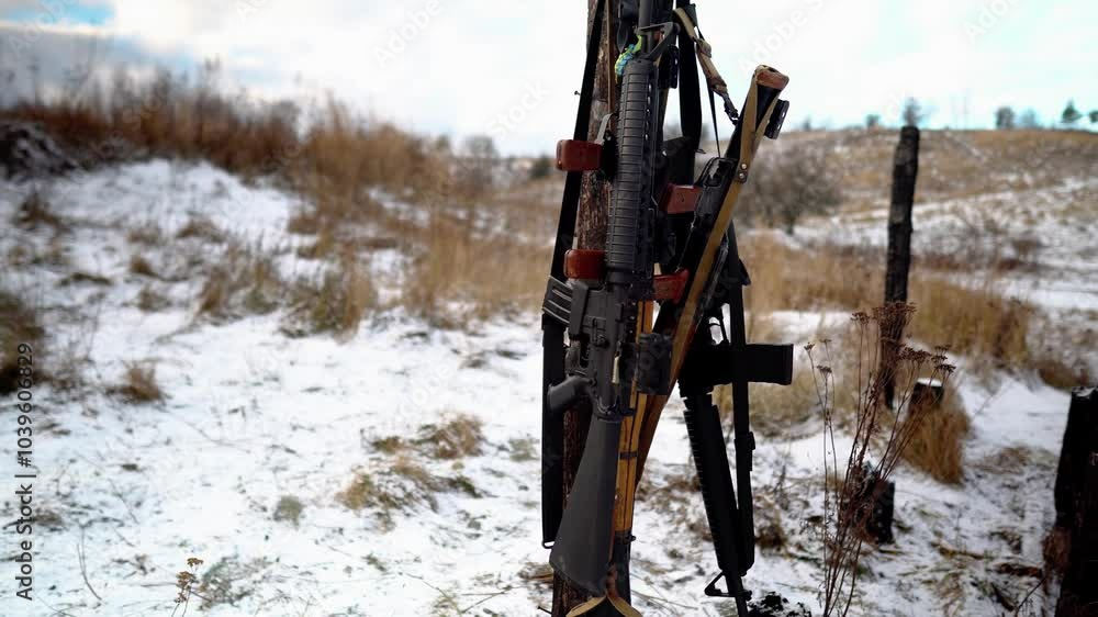Various firearms hang on a pole. Small automatic weapons. Grenade ...