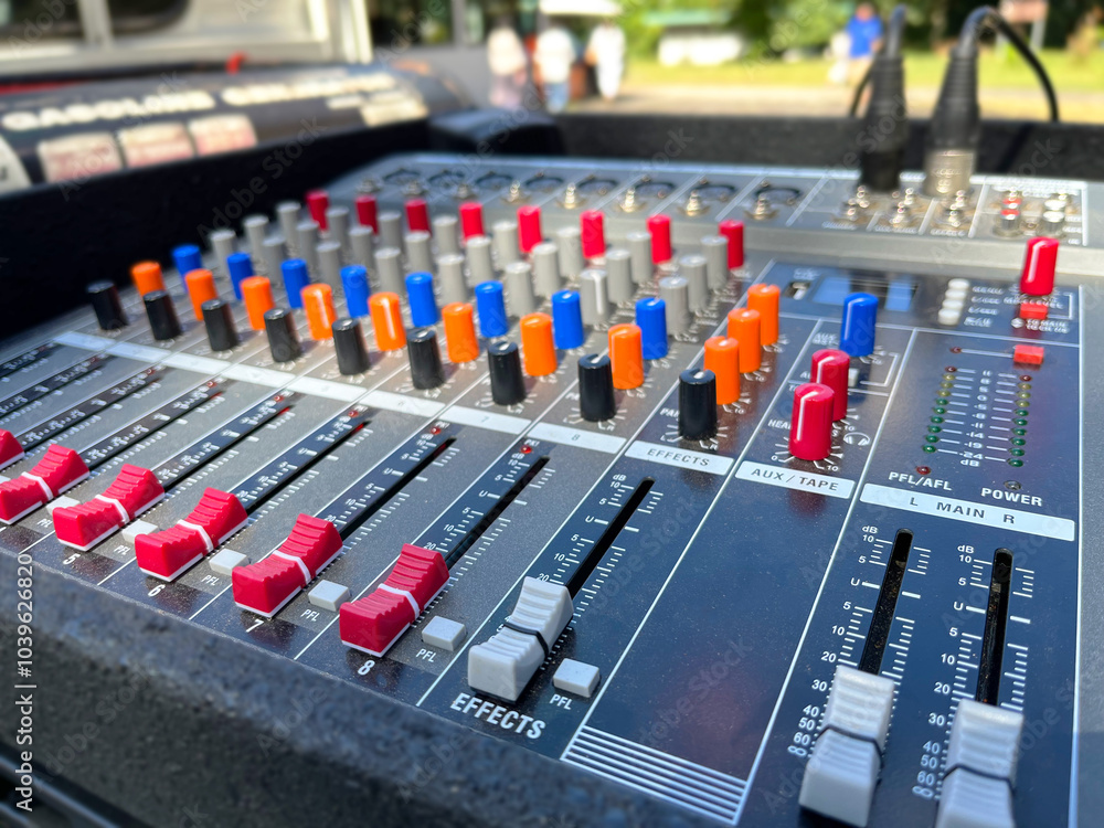 audio mixer soundboard. The mixing console features several rows of ...