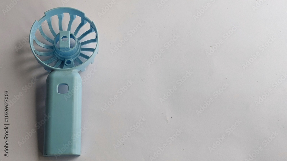 A blue plastic component with a fan-like structure. The component has a ...