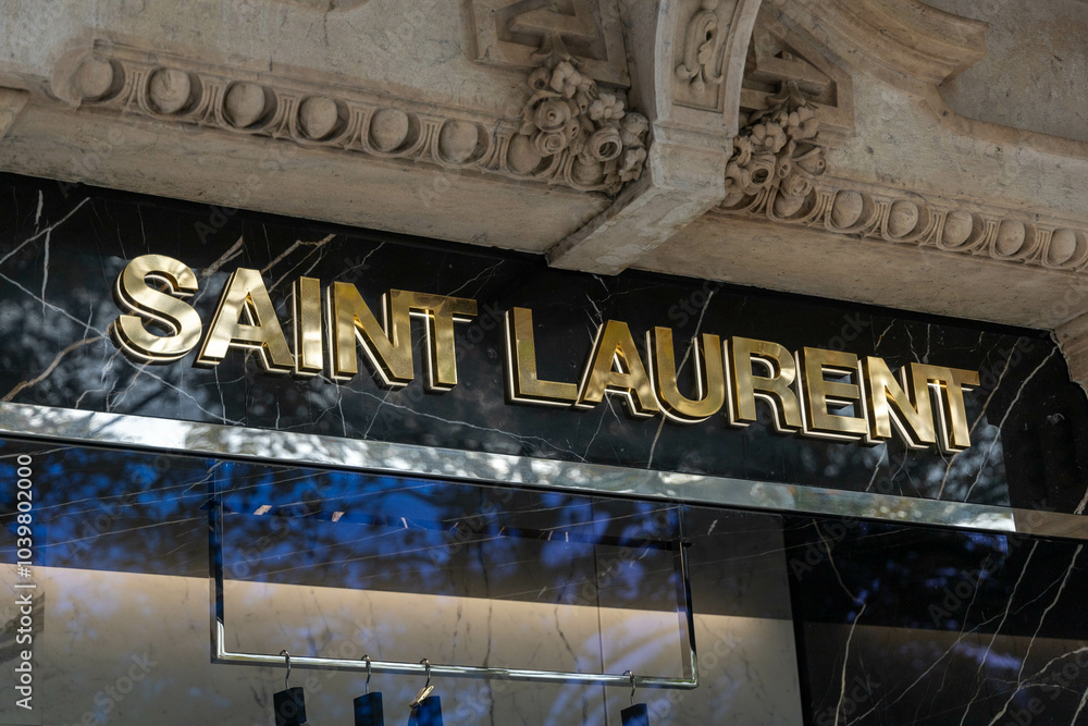 Shinny gold Saint Laurent letters logo above the shop window. Yves ...