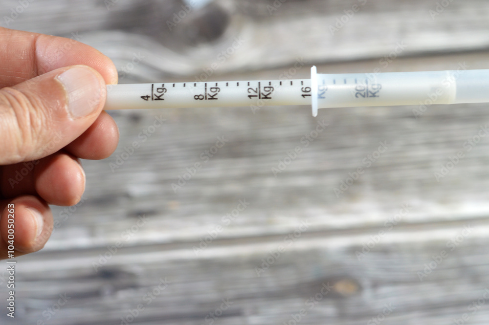 Graduated syringe in Kilograms KG for infants and children to calculate ...