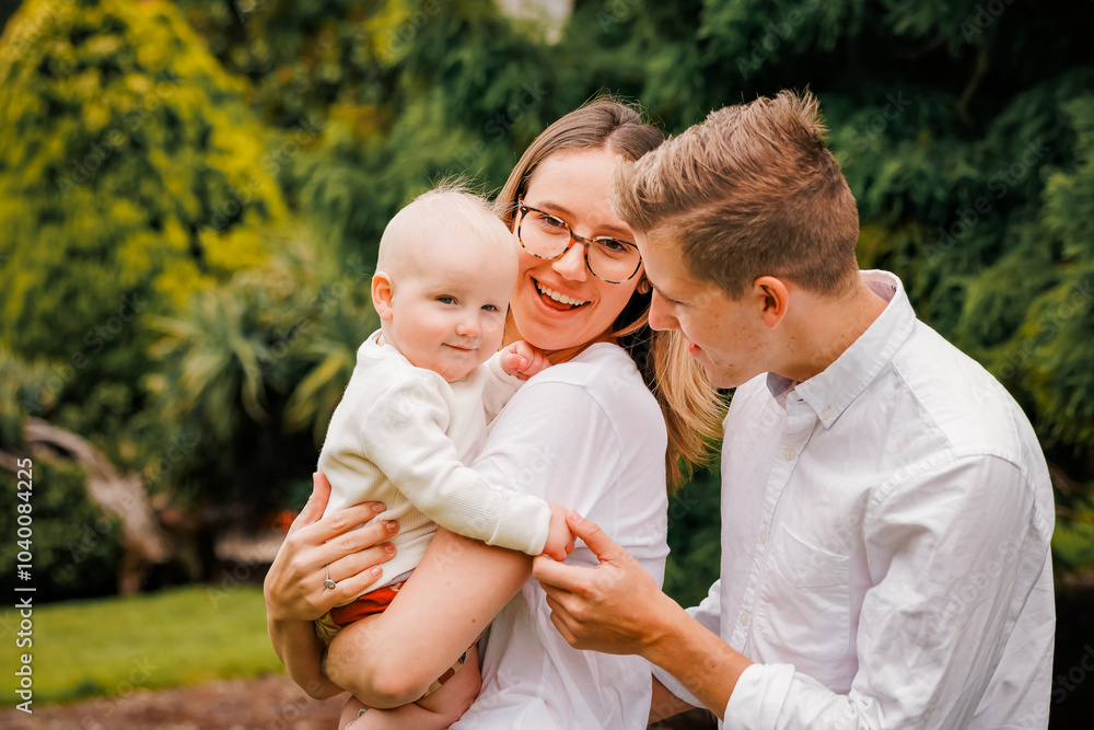 Young family of 3 with small baby at the park Stock Photo | Adobe Stock