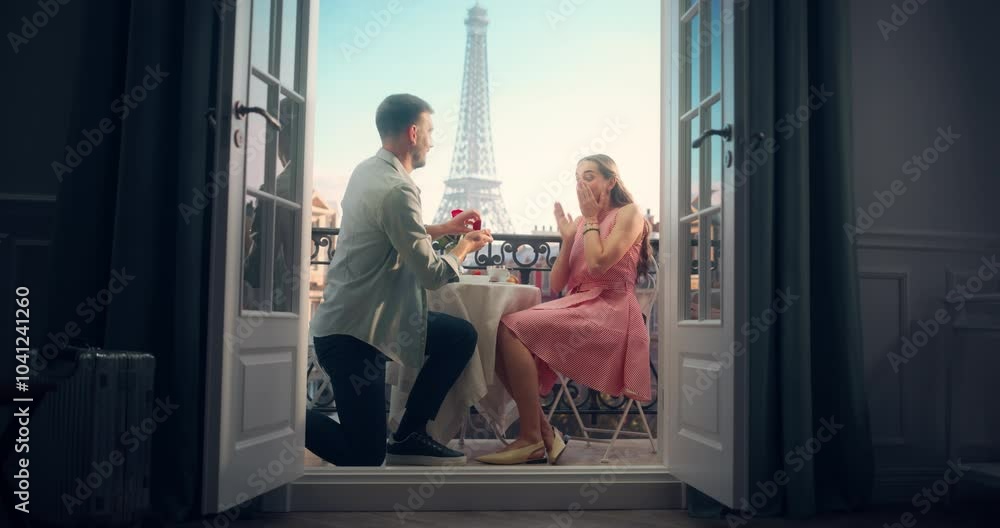 Romantic Proposal Unfolds on a Parisian Balcony as a Young Man Kneels ...