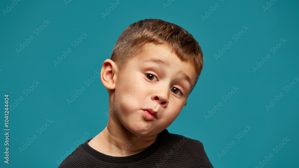 Boy's playful smirk and raised eyebrows show his curiosity. Kid in ...