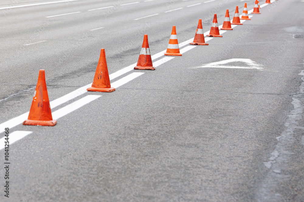 Traffic cone stands tall on freshly painted road marking, safety and ...