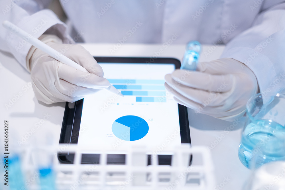 Scientist holding test tube beaker laboratory results report on tablet ...