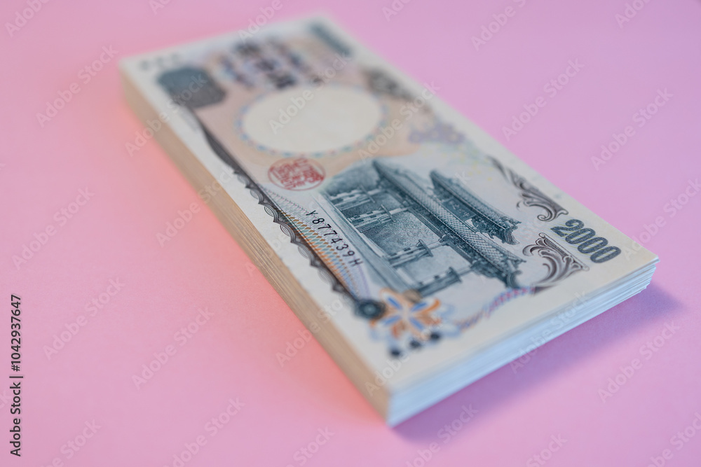 Japanese 2000 yen banknotes on a trendy pink background highlighting ...