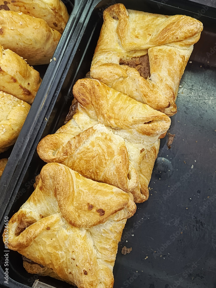 The puff pastry with meat is in a container. Fresh baked puff pastry ...