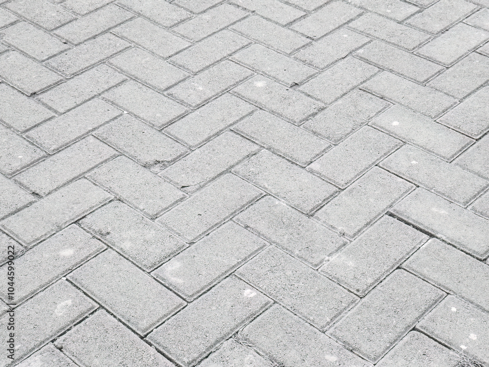 Gray herringbone pavement texture. concrete paving stones in a ...