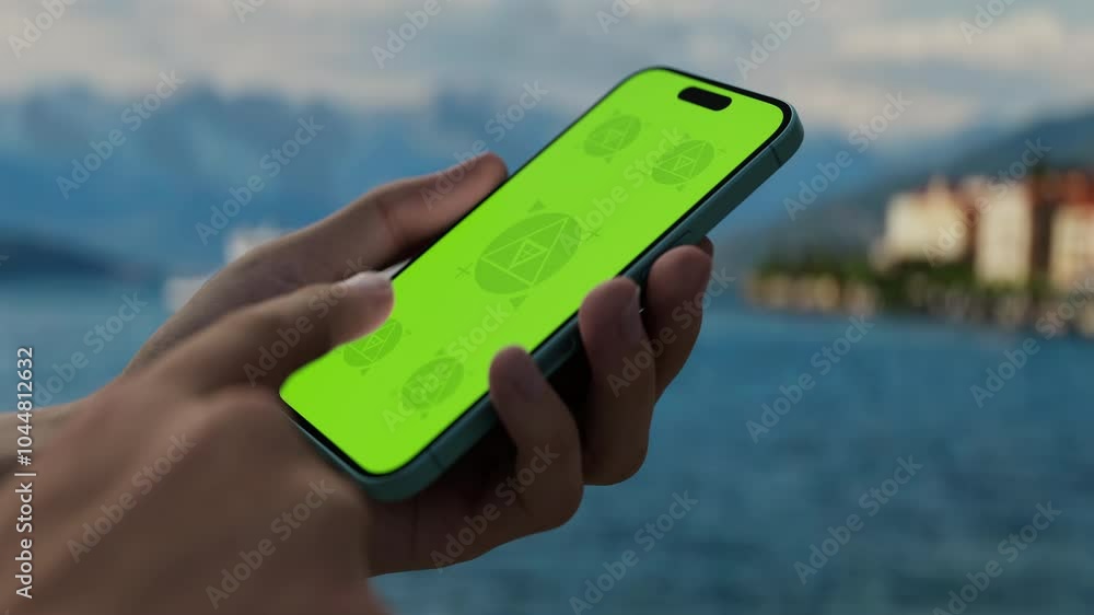 GREEN SCREEN CHROMA KEY A hand holding a smartphone with a green screen ...