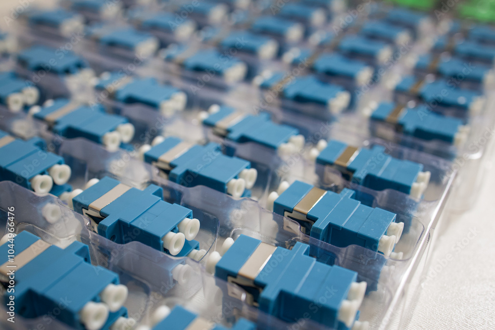 Optical adapters with different connectors in plastic blisters on the ...