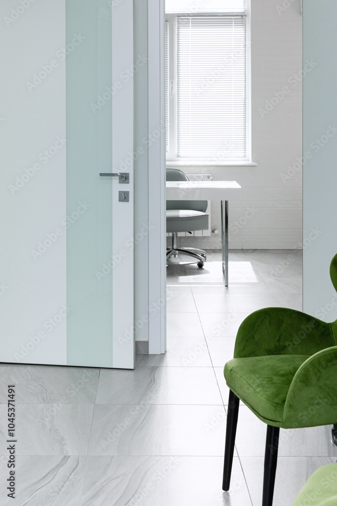 Open door and entrance to modern medical office with doctor's workplace ...