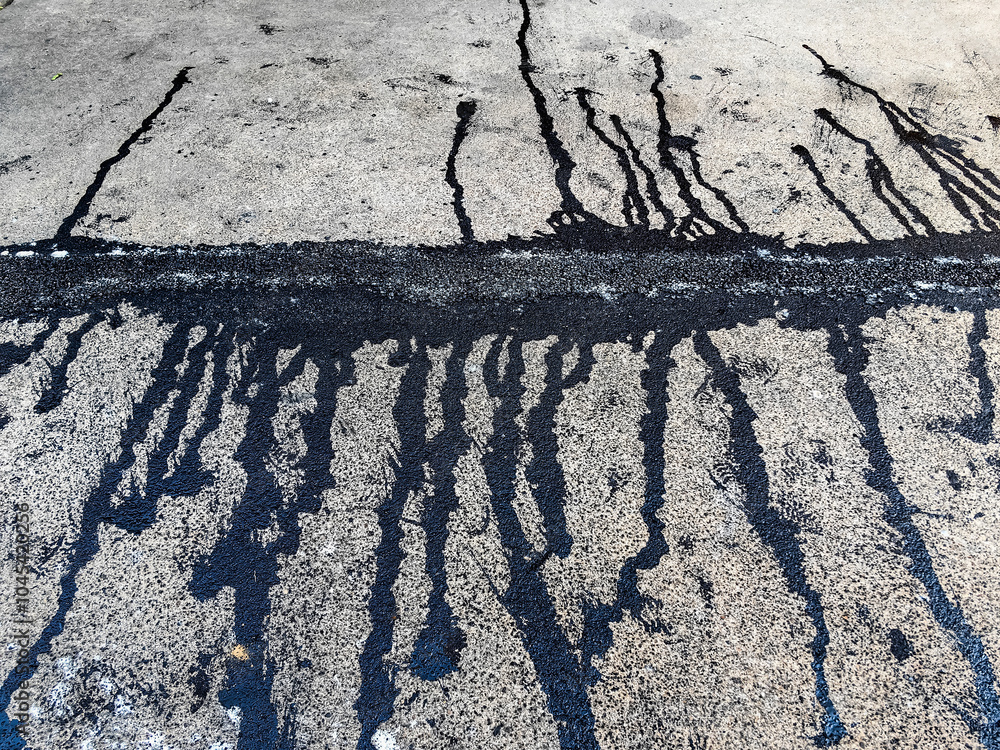 Asphalt on road. Street with black tar filling the cracks. Cracks in ...