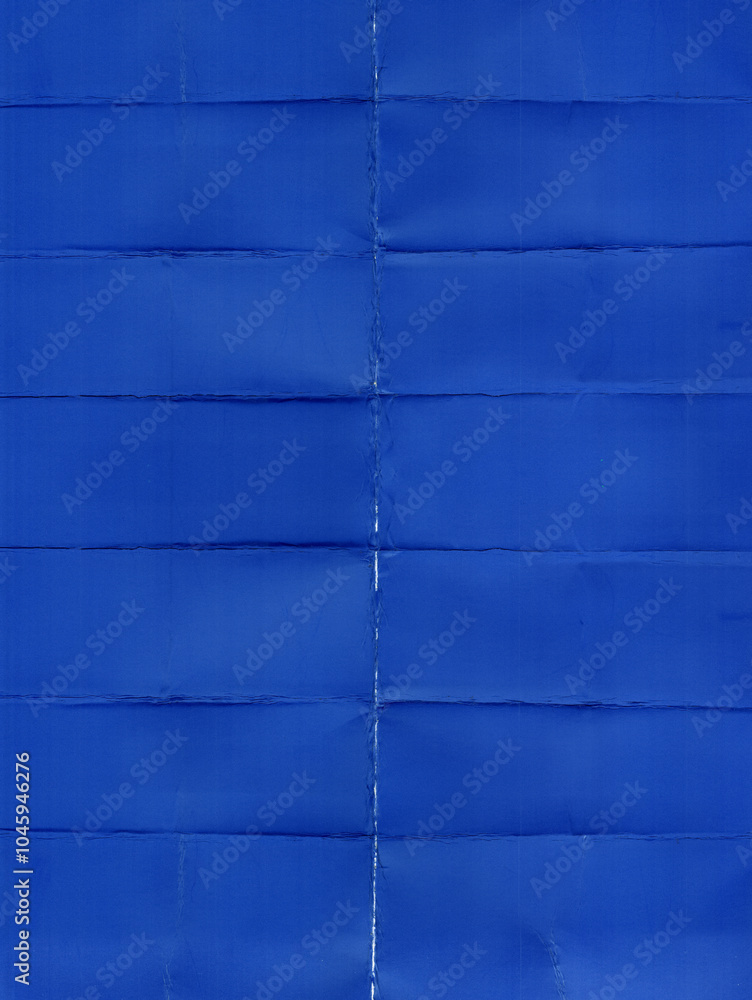 A flat blue paper texture with vertical folds, evenly sized and ...