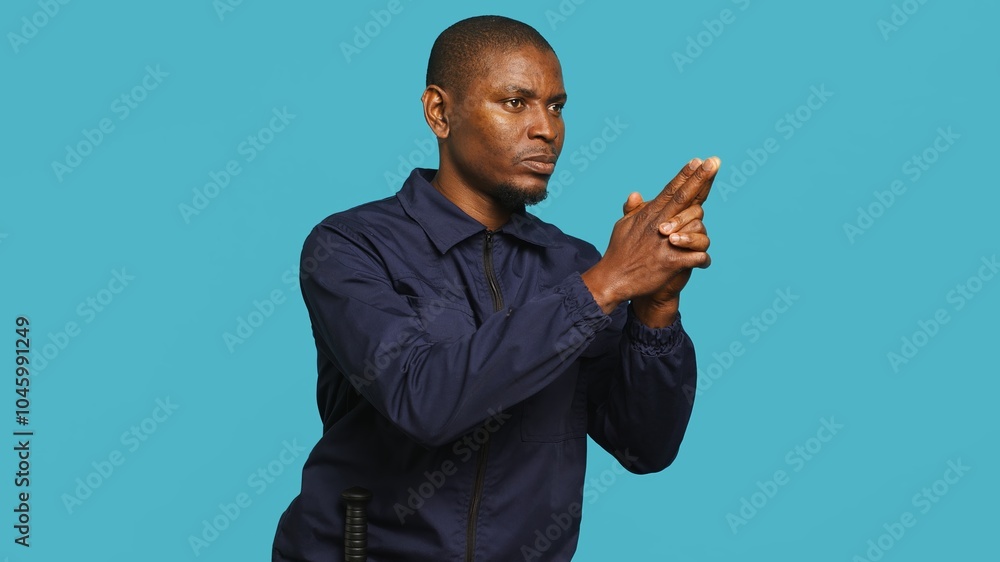 Security guard doing pretending to shoot gun hand gesture while being ...