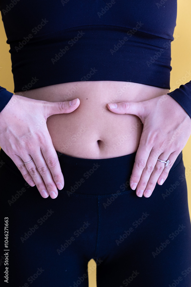Person holding their waist, belly, tummy. Perhaps constipation ...