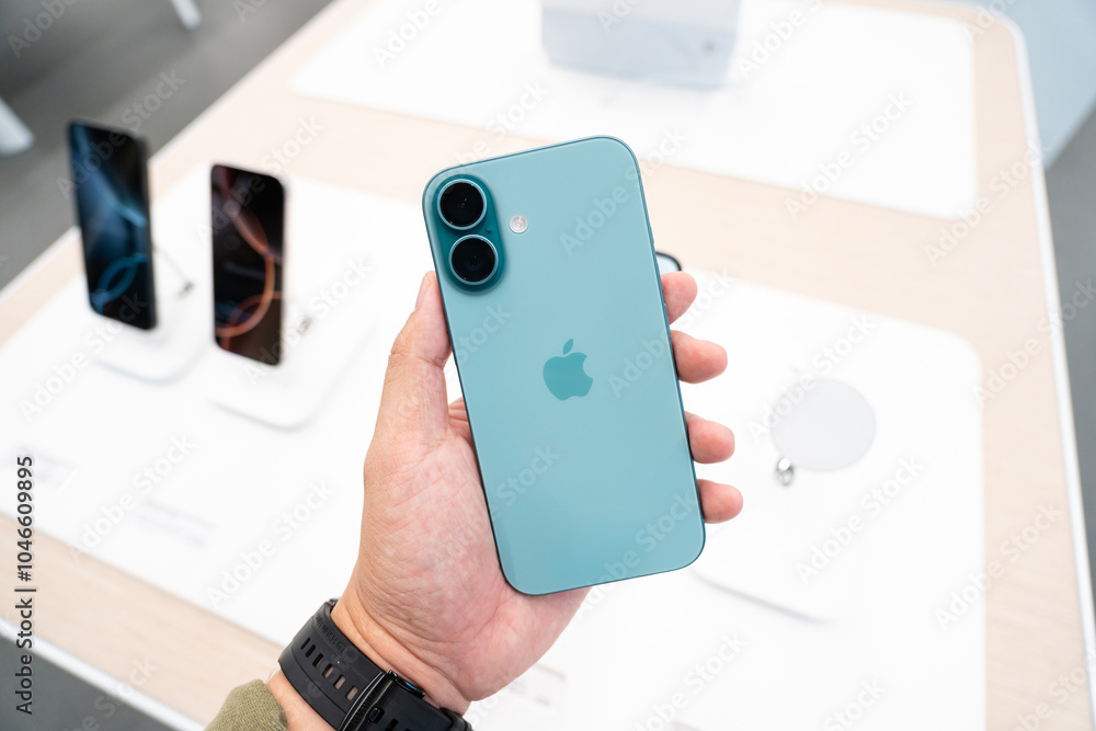 Apple launch new smartphone iPhone 16 plus displayed in a Store. Hand ...