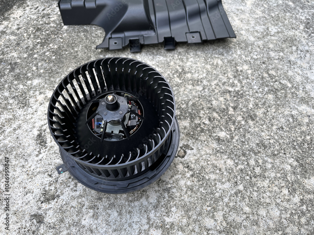 old heating and ventilation fan motor is taken out to clean and ...