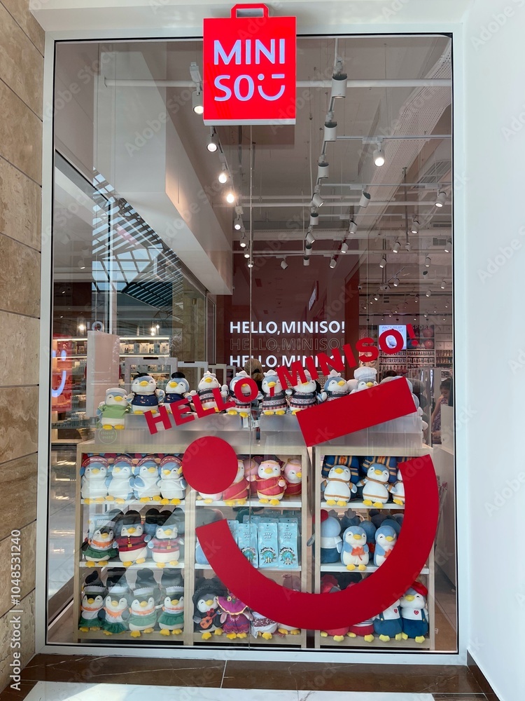 Brand MINISO store, view of shop window. Bright red MINISO! sign and ...