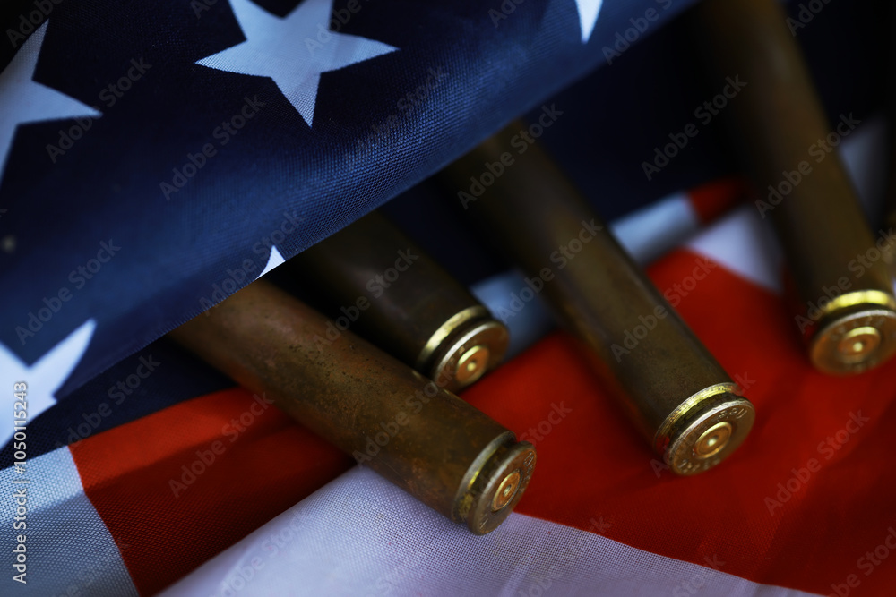Many bullets cartridges and medals on United States flag. Concept of ...