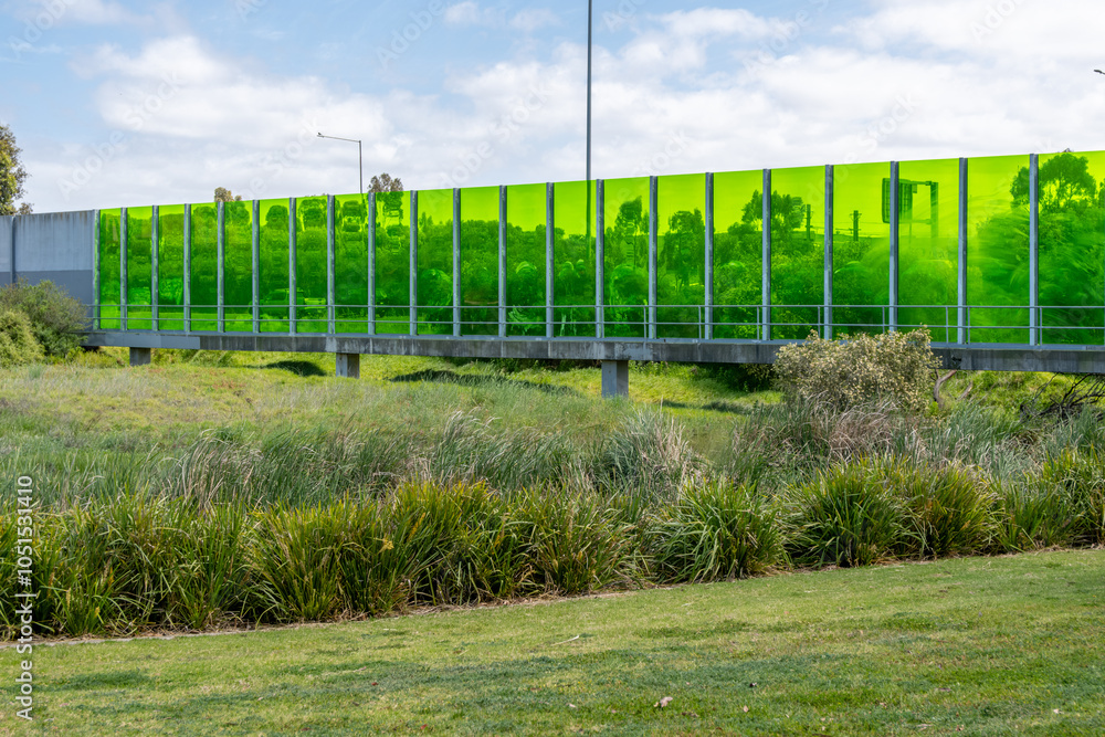 A functional and visually appealing noise wall stands tall, providing ...