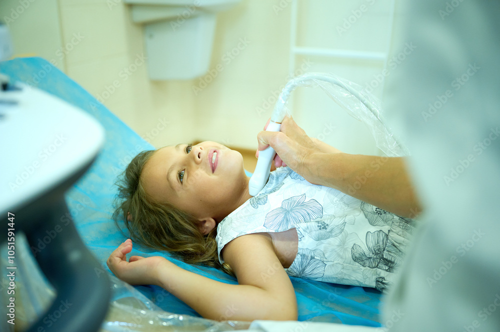 Close up of doctor making thyroid sonogram for kid. Pediatric ...